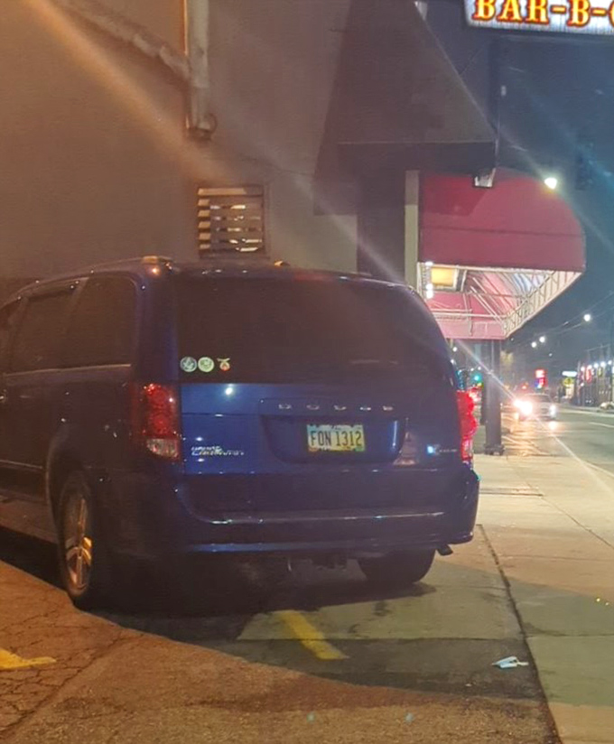 Night falls on Hickory Bar-B-Q, but the burgundy awning glows like a lighthouse for hungry travelers seeking smoky salvation.