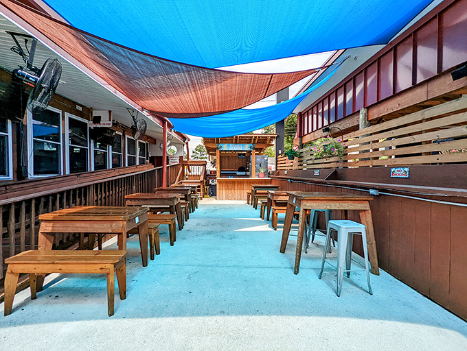The outdoor patio, shaded by colorful canopies, offers a perfect setting for cracking crabs without worrying about the mess. Freedom!
