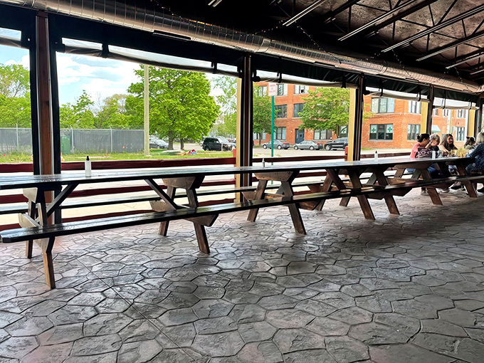 Picnic tables on the patio where summer evenings stretch long and slider combinations get increasingly adventurous.