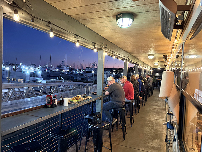 The sunset bar seating offers front-row tickets to nature's nightly show, with boats and birds providing the entertainment.