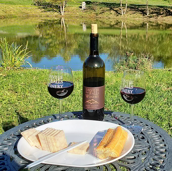 Wine with a view&mdash;Linville Falls' Petit Verdot pairs beautifully with local cheese and the reflection of trees dancing on water.