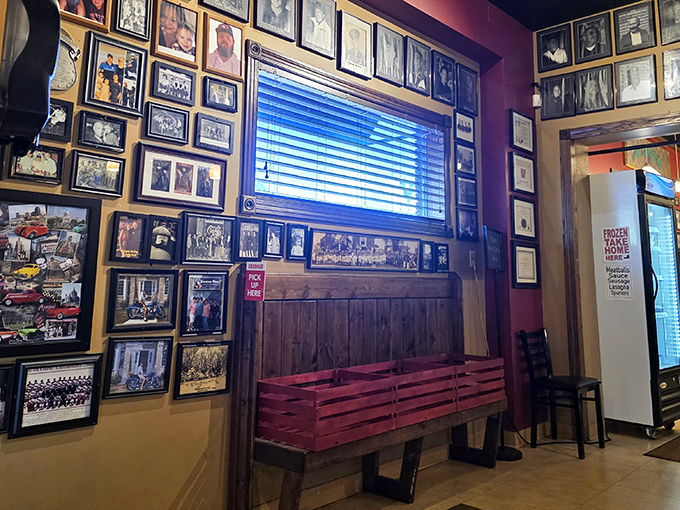 A wall of memories surrounds diners with the restaurant's rich history. Each photo frame holds a chapter in this ongoing Italian-American love story.