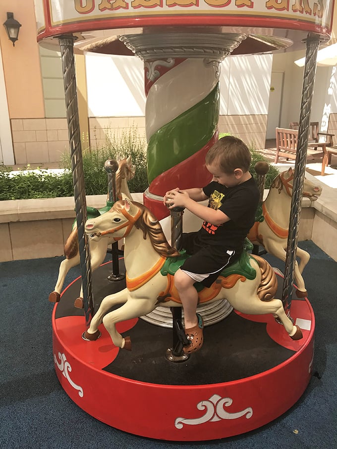 Childhood wonder meets retail reality on this classic carousel. This little cowboy's shopping break is the perfect distraction while parents' credit cards cool down. 