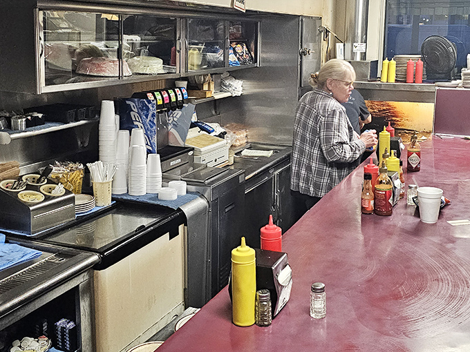 This isn't just a prep area—it's command central where burger magic happens amid bottles of mustard standing at attention.