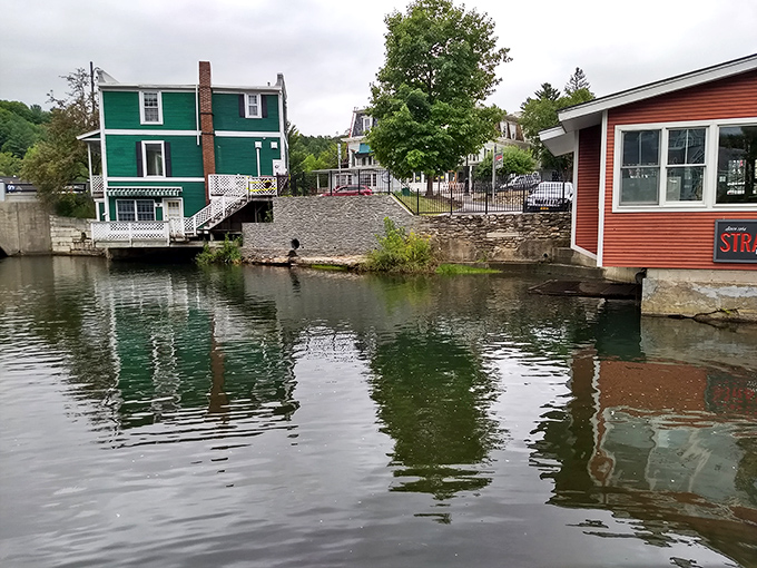 Manchester's waterways reflect the colorful buildings, creating a postcard-perfect scene that makes you forget you came here to shop.