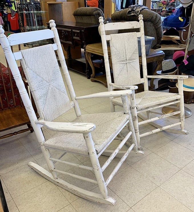 White rocking chairs with woven seats that have already witnessed countless porch conversations, ready for many more.