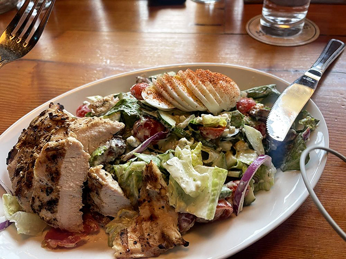 A salad that actually excites: fresh greens, perfectly grilled chicken, and what appears to be a sliced egg bringing protein-packed joy to the party.