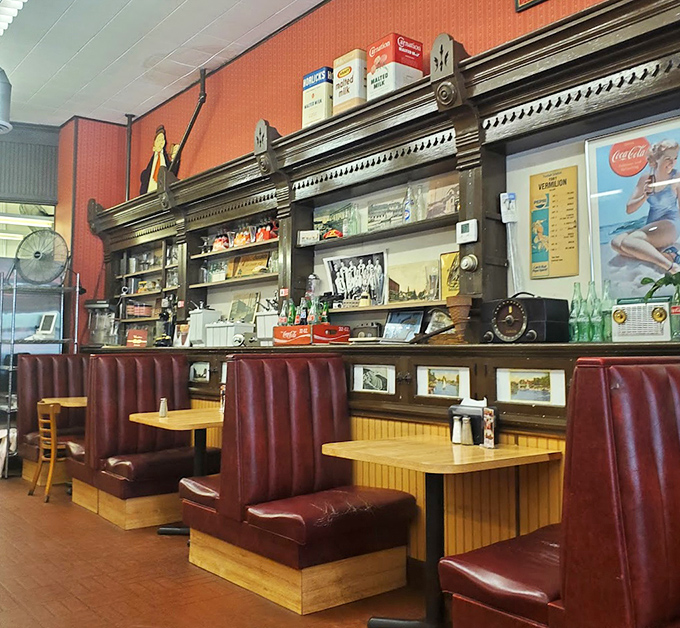 Burgundy booths and retro charm create the perfect setting for conversations that actually happen without phone interruptions.