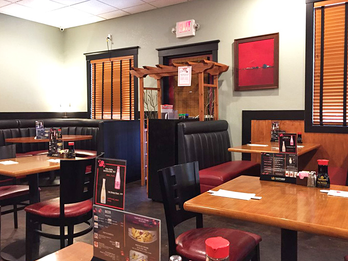 Traditional booth seating offers cozy nooks for intimate dining. That wooden pagoda divider isn't just decoration &ndash; it's creating little worlds for each table.