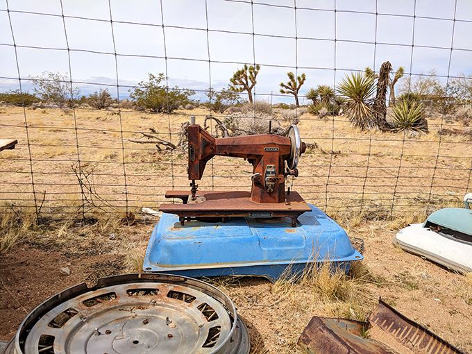 A lonely sewing machine contemplates the vast desert landscape, wondering if it could stitch together the torn fabric of our consumer society.