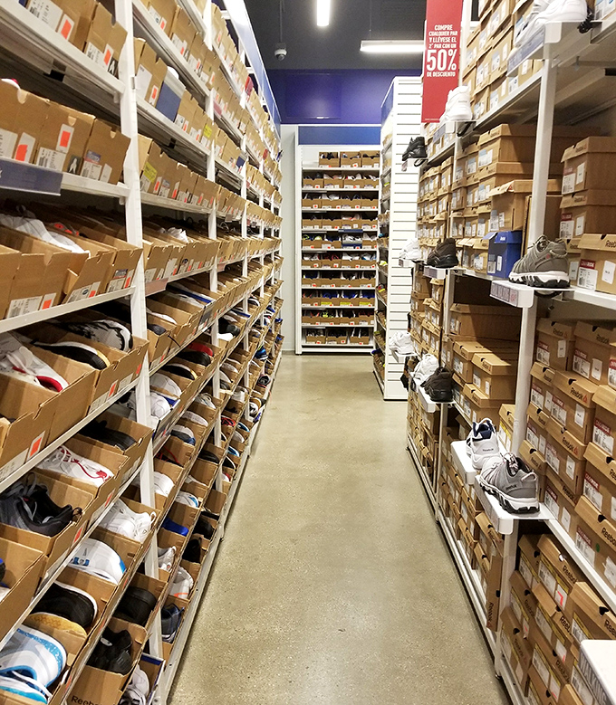 The shoe stockroom that resembles a sneaker library &ndash; organized chaos where your perfect pair waits patiently for discovery.