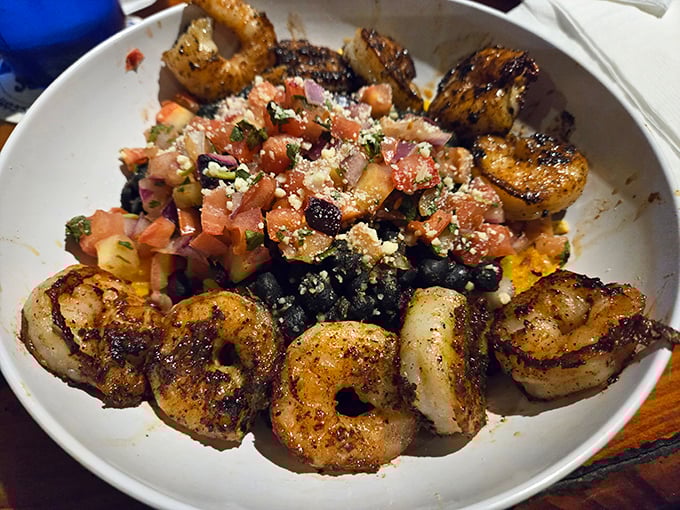 Blackened shrimp dancing around fresh pico de gallo &ndash; a bowl that captures the essence of Gulf Coast cuisine in one perfectly composed seafood symphony.