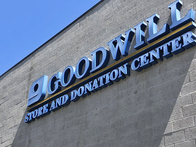The iconic Goodwill sign against a California blue sky. This beacon of sustainable shopping has transformed retail therapy into community support.