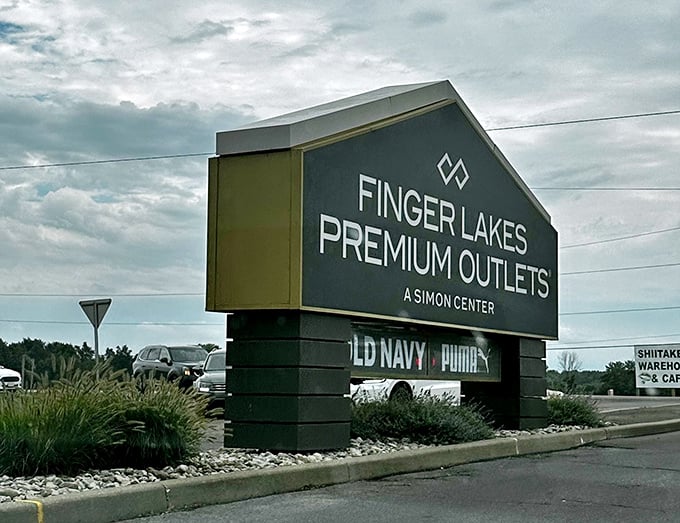The Finger Lakes Premium Outlets sign stands as a beacon of hope for fashion lovers and a warning to credit card companies everywhere.