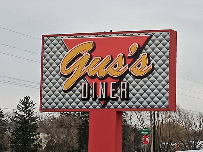 The roadside sign stands proud, like a retro superhero announcing "Fear not, hungry travelers&mdash;satisfaction lies just ahead!"