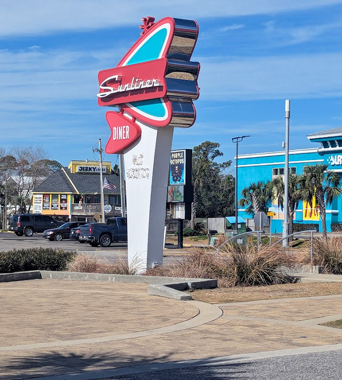 That sign isn't just advertising&mdash;it's a retro-futuristic promise of culinary delight that stands out against the Alabama sky like a delicious landmark.