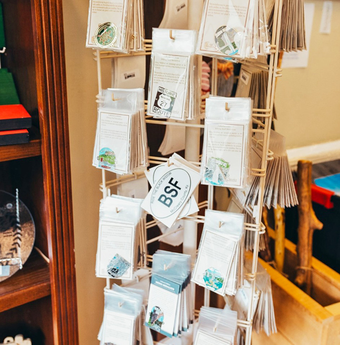 Spinning rack of possibilities &ndash; each postcard a portal to adventures you've just had or ones still waiting around the bend.