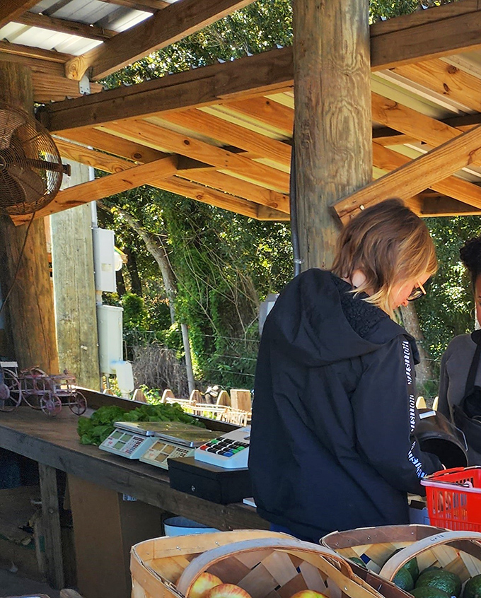 Under rustic wooden beams, the farm stand creates a shopping experience that makes even grocery store executives weep with envy.