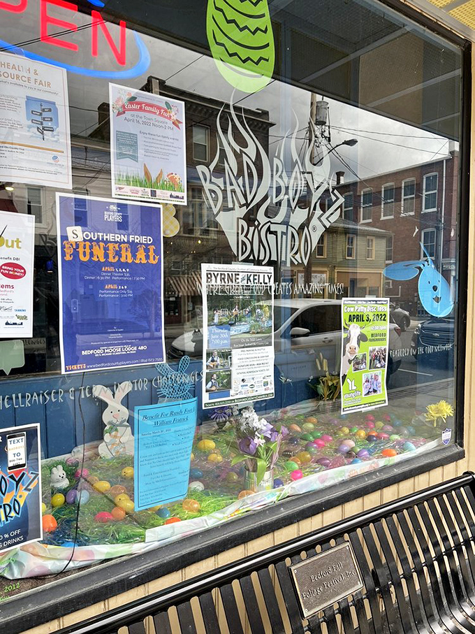 The storefront window doubles as a community bulletin board&mdash;local events and seasonal decorations connecting food with neighborhood happenings.