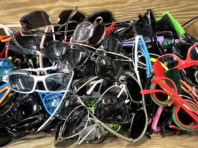 A jumble of sunglasses where designer knockoffs mingle with authentic vintage finds. Someone's discarded frames could become your signature look.