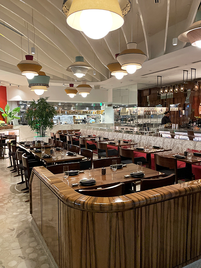 The dining room's curved wooden details and thoughtful layout create intimate dining pockets within the larger space&mdash;perfect for both celebration and conversation.