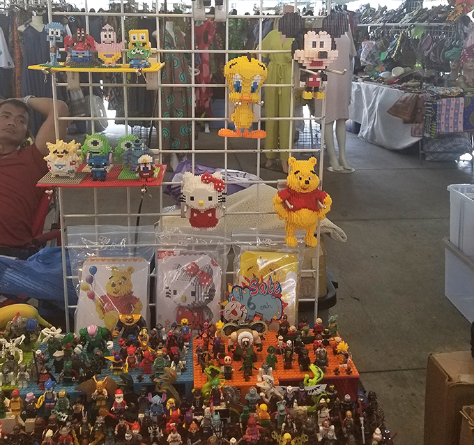 Blocky characters and miniature figures create a toy collector's dream landscape. Childhood nostalgia meets artistic craftsmanship in plastic form.