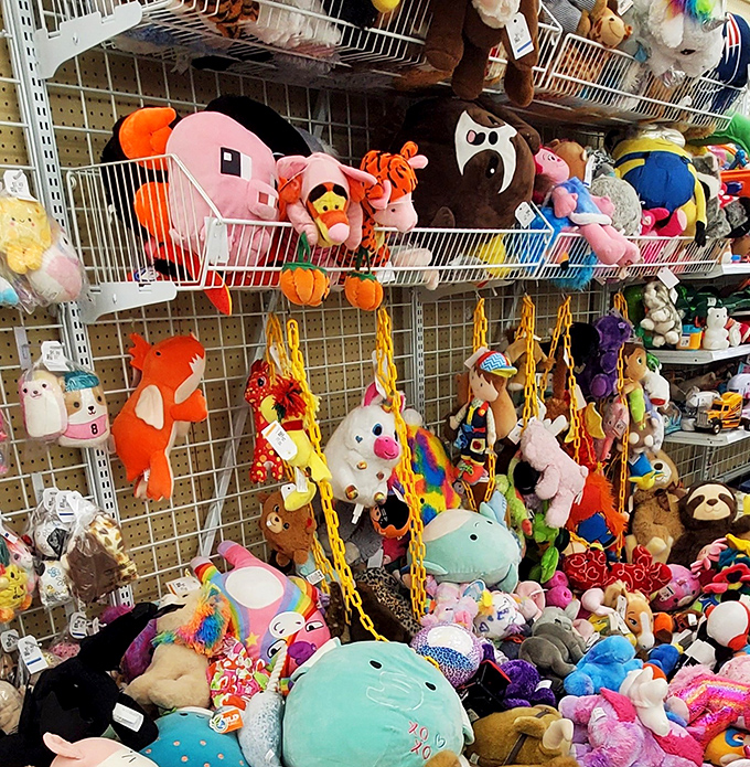Stuffed animal paradise where forgotten friends wait for new hugs. That pink creature might not be anatomically correct, but it's full of love.