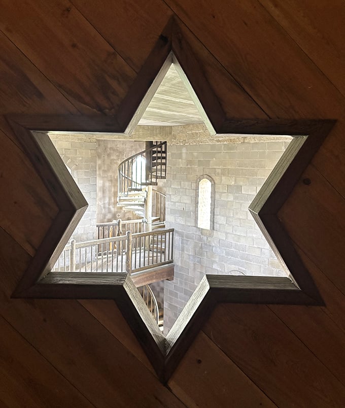 This star-shaped opening offers a unique perspective of the interior staircase&mdash;architectural whimsy that adds to the castle's charm.