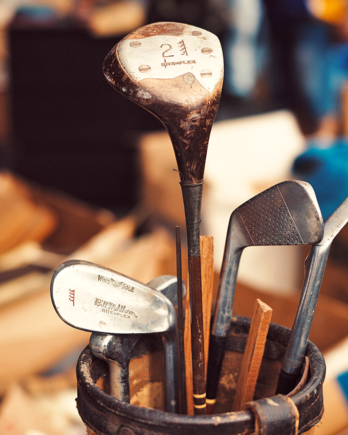 Golf clubs with character. These vintage woods and irons have likely seen more courses than most golfers, each ding and scratch a testament to games past.
