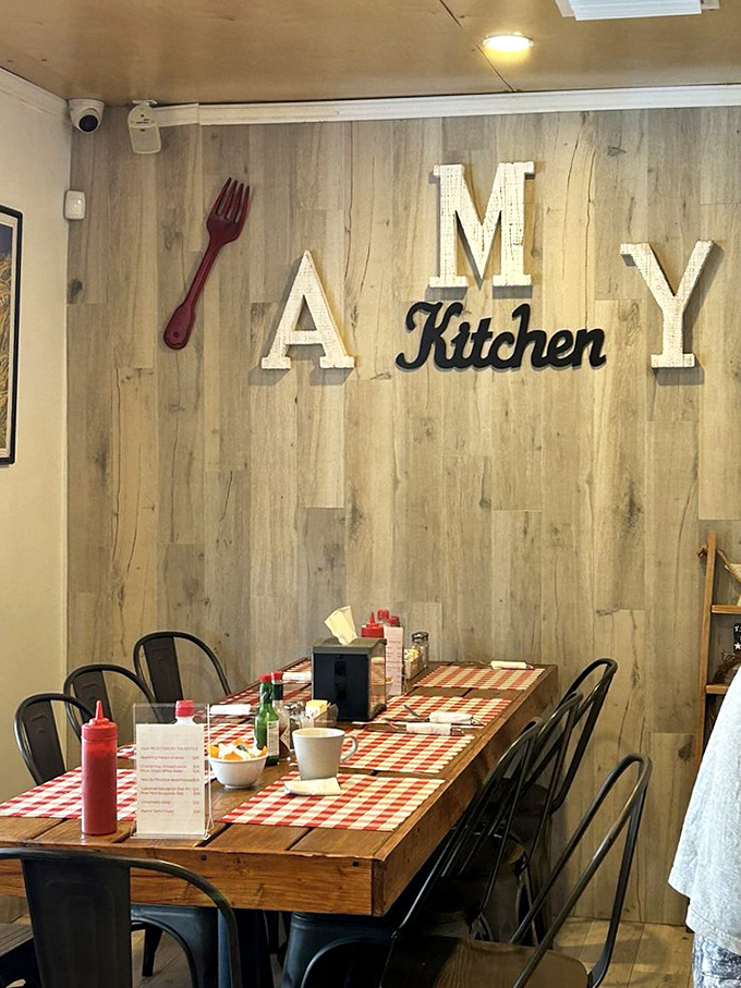 The "AMY Kitchen" wall décor, complete with oversized wooden fork, sets the homey tone that makes this bistro feel like a culinary hug.