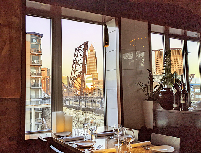 Floor-to-ceiling windows frame Cleveland's iconic bridges and skyline. Dinner with a view that reminds you why the Midwest has its own kind of magic.