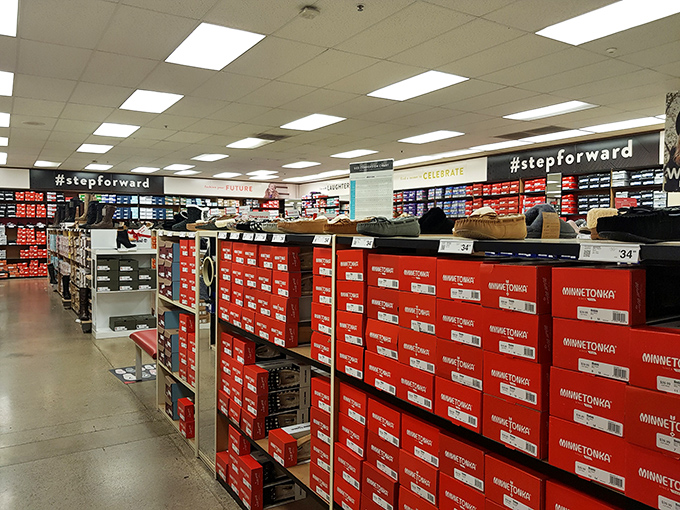 Shoe paradise stretches as far as the eye can see. The "#stepforward" sign is both instruction and inevitable consequence.