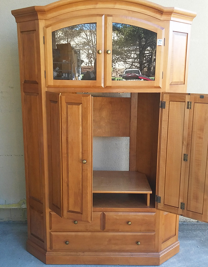 This solid wood entertainment center remembers the days of bulky TVs and VCRs. Now it awaits reinvention as a bookcase, bar, or statement piece.