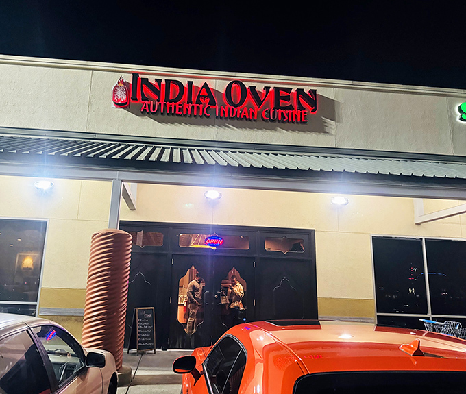 India Oven's glowing sign cuts through the night, a beacon for curry lovers in Sacramento.