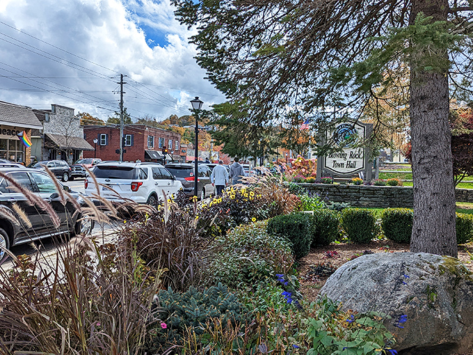 The welcoming entrance to Blowing Rock showcases beautiful landscaping and the town's famous sign surrounded by colorful autumn foliage.