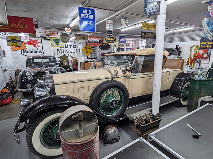 Surrounded by vintage gas pumps and nostalgic signs, this cream-colored Hudson convertible waits patiently, as if its owner just popped in for a malted milk in 1928.