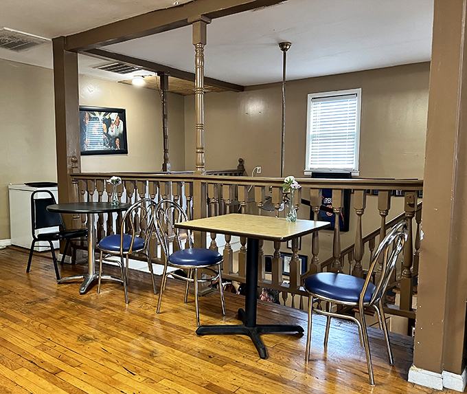 Upstairs seating offers a quiet retreat with wooden floors and simple furnishings—because nothing should distract from the food downstairs.