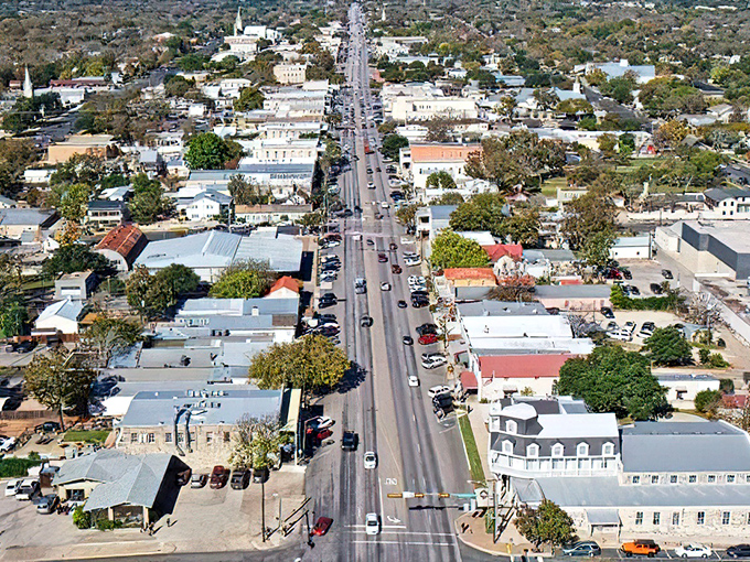 From above, Fredericksburg reveals its perfect planning—a tidy grid of history, commerce, and community stretching toward the surrounding Hill Country landscape.