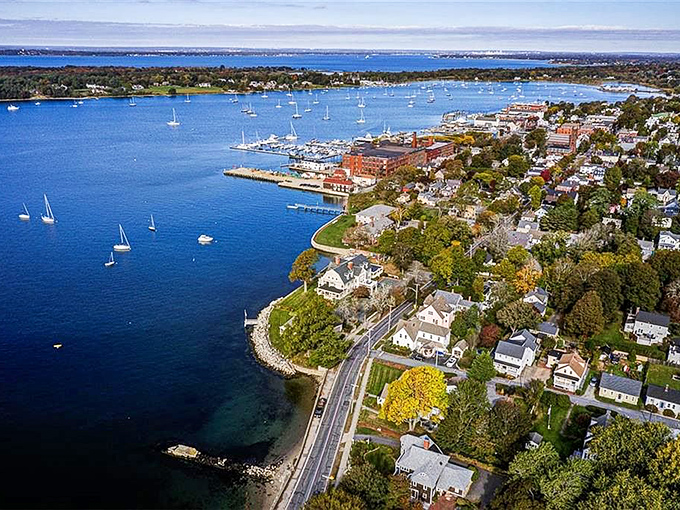 From above, Bristol reveals its true character: a perfect peninsula where colonial charm meets maritime splendor in Rhode Island's bluest waters.