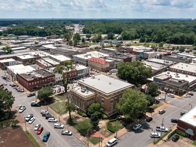 Aerial perspective reveals Corinth's compact, walkable downtown where everything sits conveniently close without requiring marathon hiking expeditions daily.