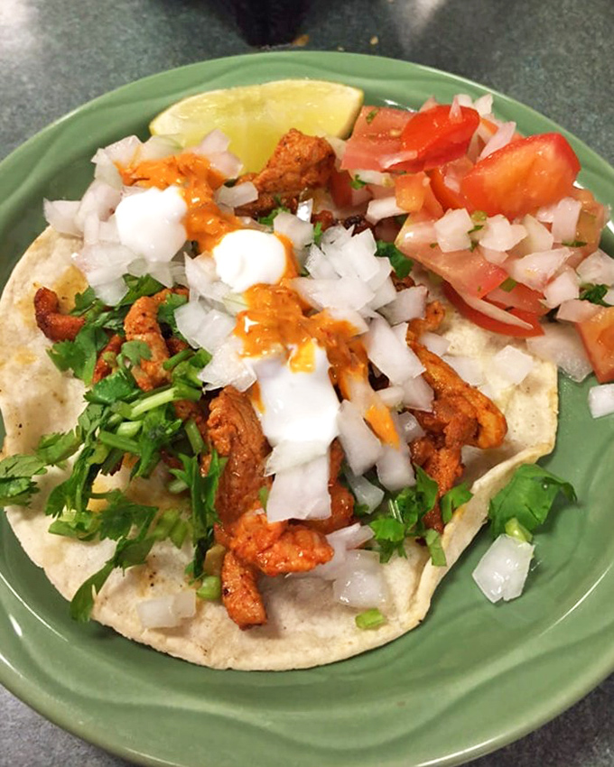 The al pastor taco&mdash;a perfect handheld masterpiece. Marinated pork with pineapple's sweet kiss, topped with cilantro and onion in perfect proportion. Lime standing by. 