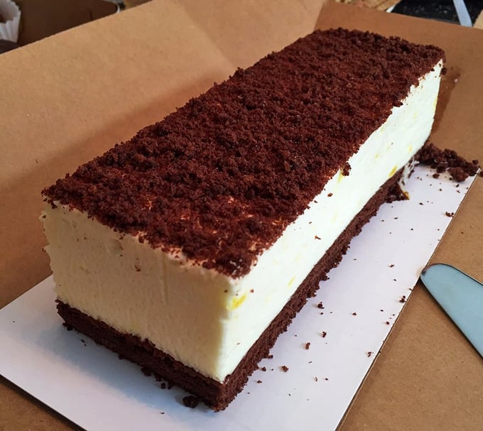This isn't just cheesecake&mdash;it's a geometric marvel of dairy perfection. The chocolate crumb border stands guard around a kingdom of creamy delight.