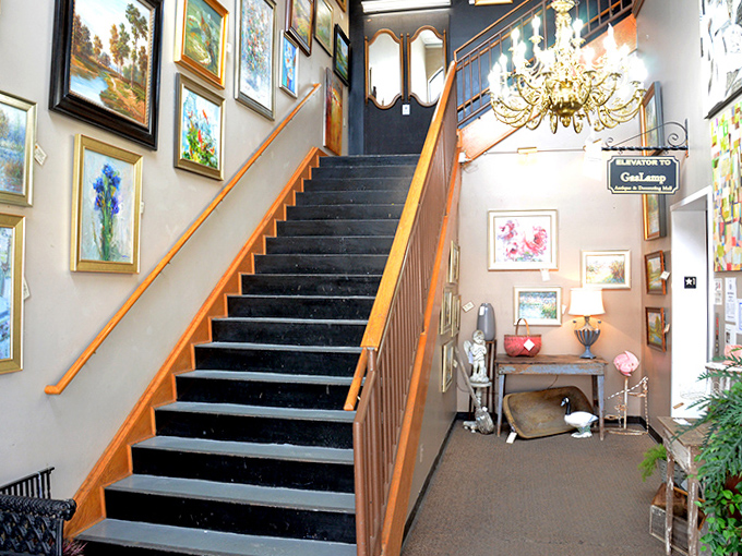 The stairway gallery creates a dramatic ascent to the second floor, proving that at GasLamp, even the journey between floors is curated art.