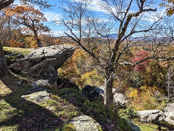 The path along the ridge reveals new perspectives with every step. These ancient rocks frame fall's finest artwork.