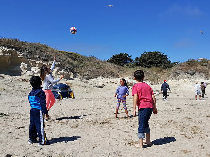 Beach volleyball in progress—where "I haven't played since college" meets "sand in places you'll be finding for days."