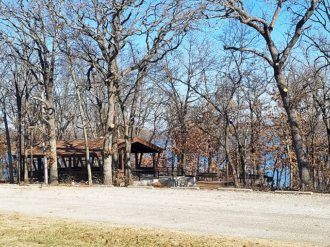 Big Hill Lake's rustic shelter invites visitors to pause, picnic, and appreciate the simple pleasure of trees meeting water under vast Kansas skies.