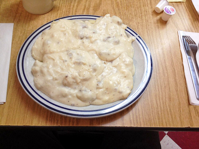 Biscuits drowning happily in peppery sausage gravy. Not all heroes wear capes&mdash;some wear flour and arrive on a blue-rimmed plate.