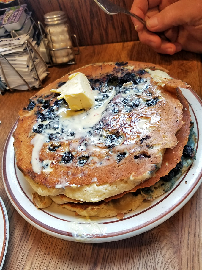 Blueberry pancakes where the berries aren't just participants&mdash;they're the stars of the show. Butter melting like a sunrise over breakfast paradise.