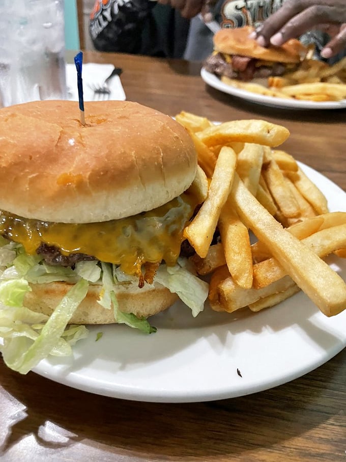 Classic burger with melted cheese and crispy fries proves sometimes the simplest approach yields the most satisfying results. 