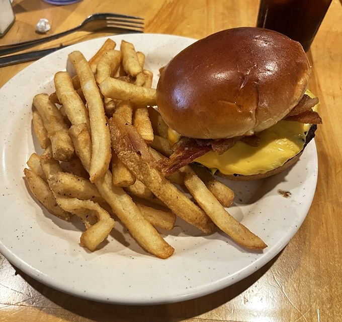 The burger that makes you pause mid-conversation. Those fries aren't sides—they're co-stars in this lunch performance deserving equal billing.